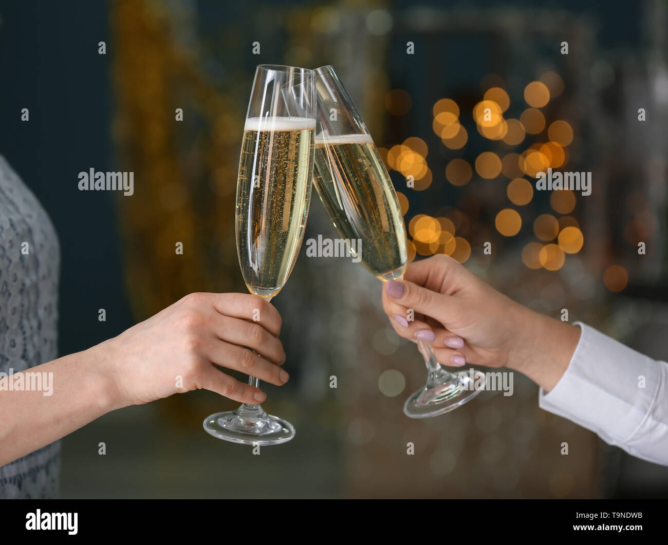 Friends clinking glasses with champagne at party Stock Photo - Alamy