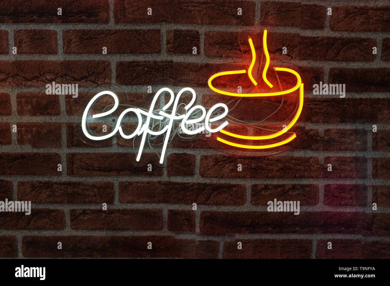 Neon sign background saying " COFFEE " Sign hanging on a wall and lit ...