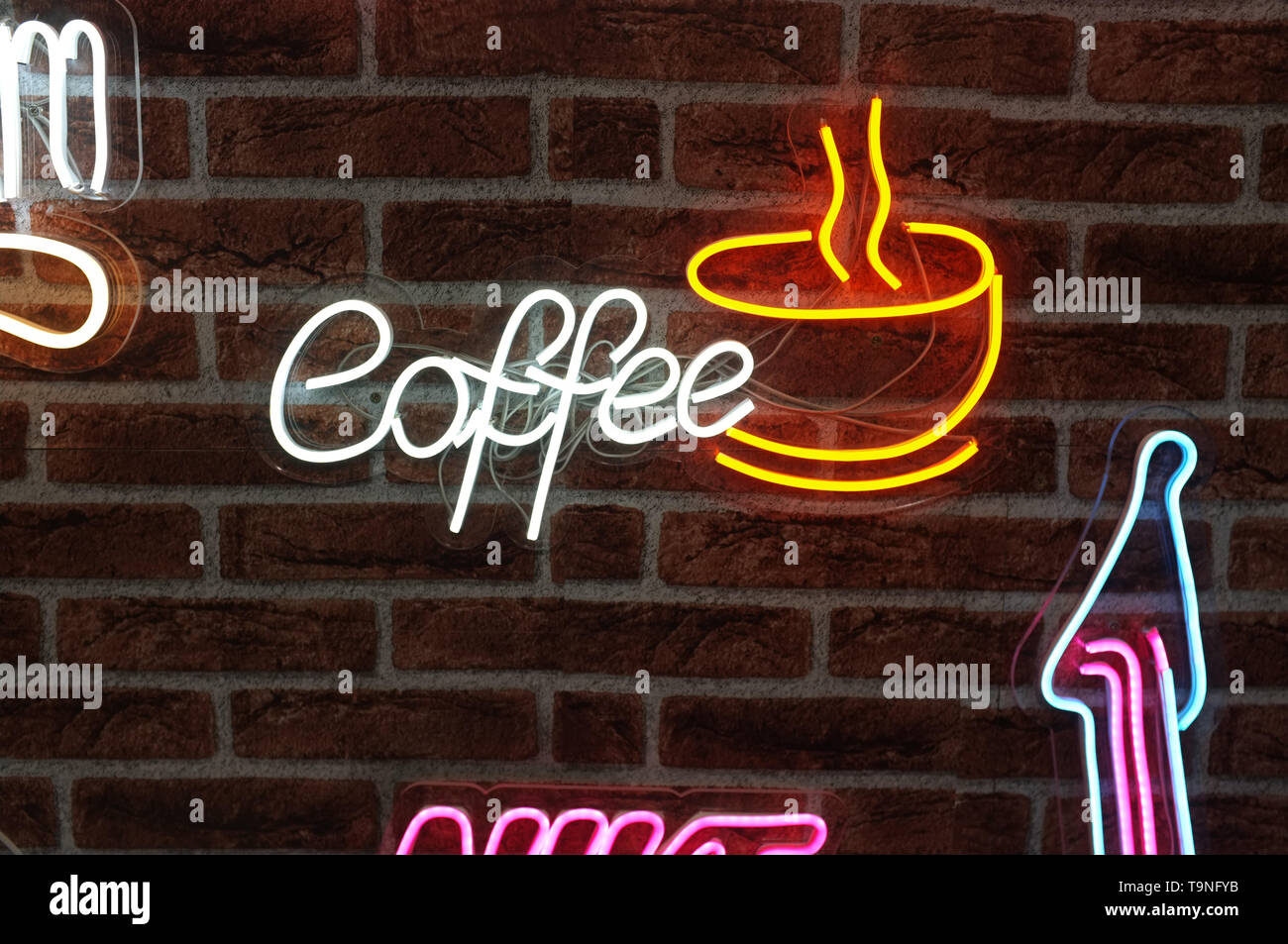 Neon sign background saying " COFFEE " Sign hanging on a wall and lit ...