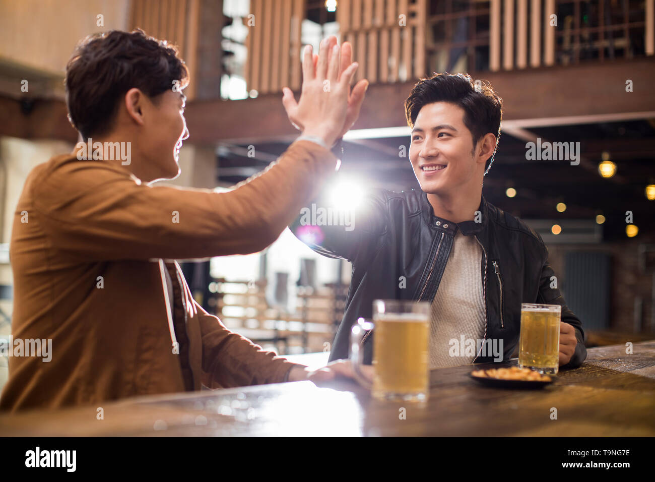 Men doing high five hi-res stock photography and images - Alamy