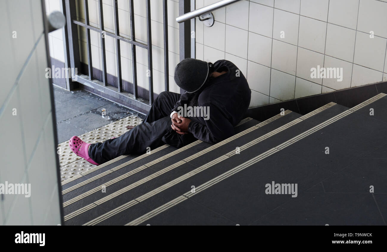 Berlin, Germany. 18th May, 2019. A homeless guy sits on stairs at a ...