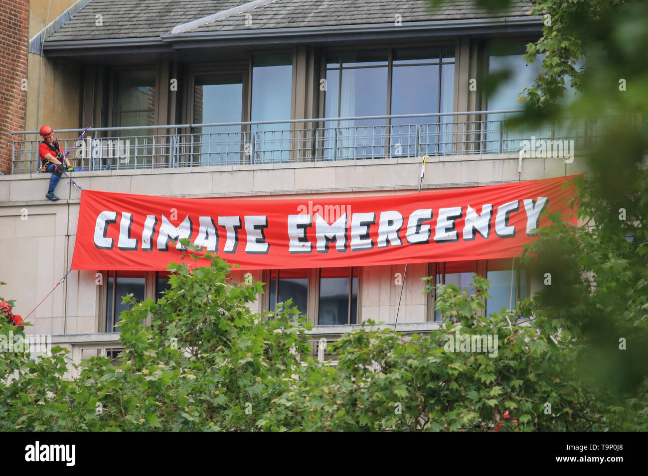 London, UK. 20th May, 2019. Greenpeace climate activists unfurl a large ...