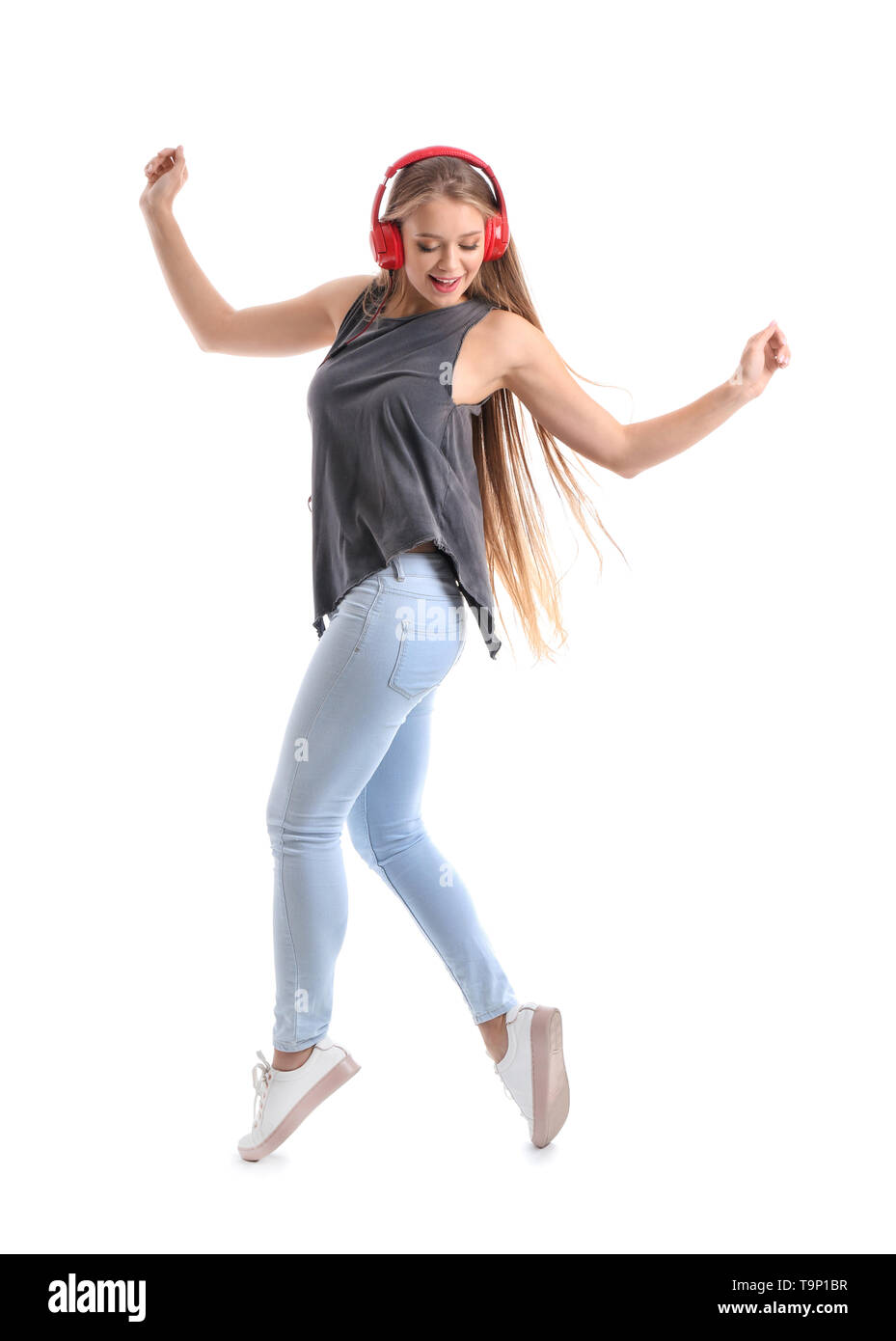 Beautiful young woman dancing on white background Stock Photo - Alamy