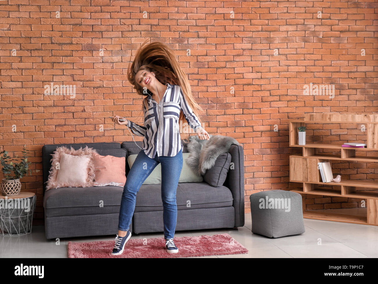 Beautiful young woman dancing at home Stock Photo - Alamy