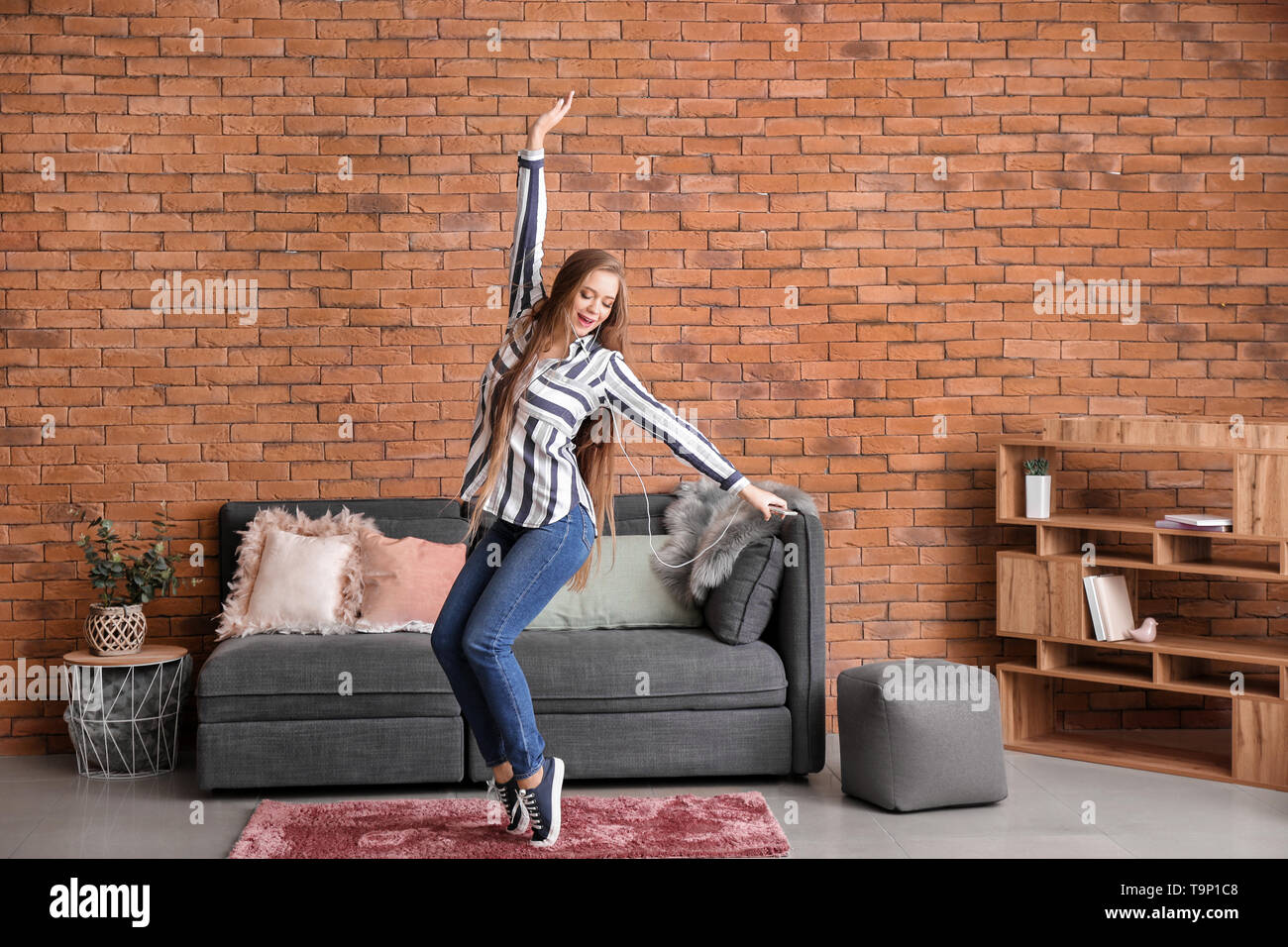 Beautiful young woman dancing at home Stock Photo - Alamy