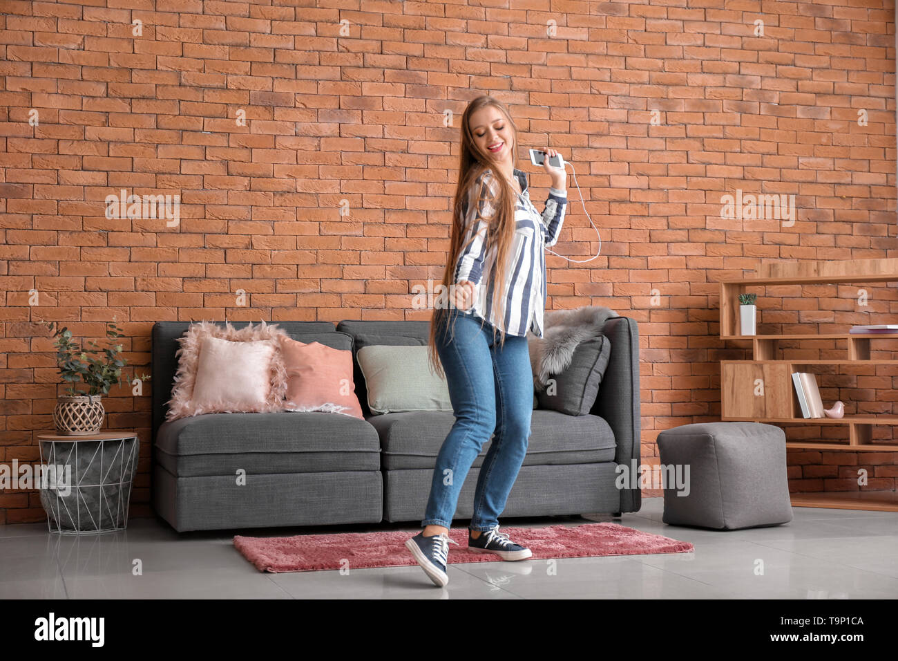 Beautiful young woman dancing at home Stock Photo - Alamy