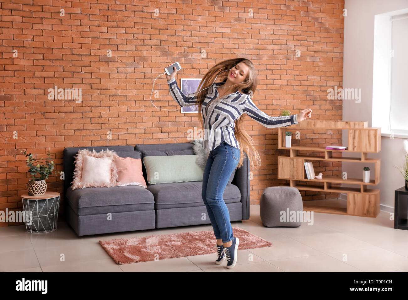 Beautiful young woman dancing at home Stock Photo - Alamy