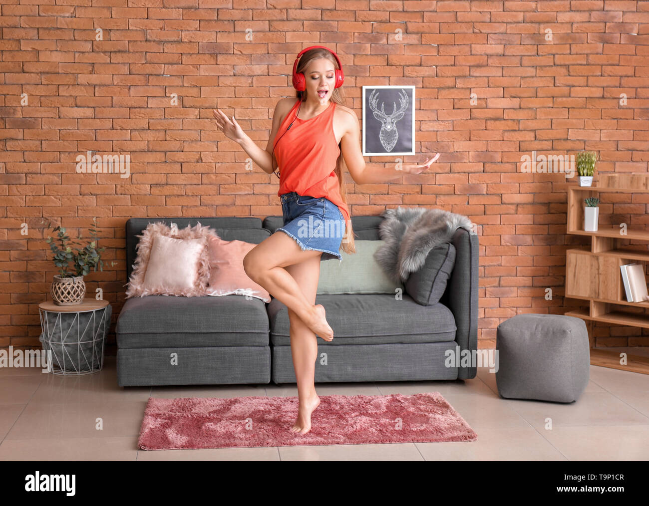 Beautiful young woman dancing at home Stock Photo - Alamy