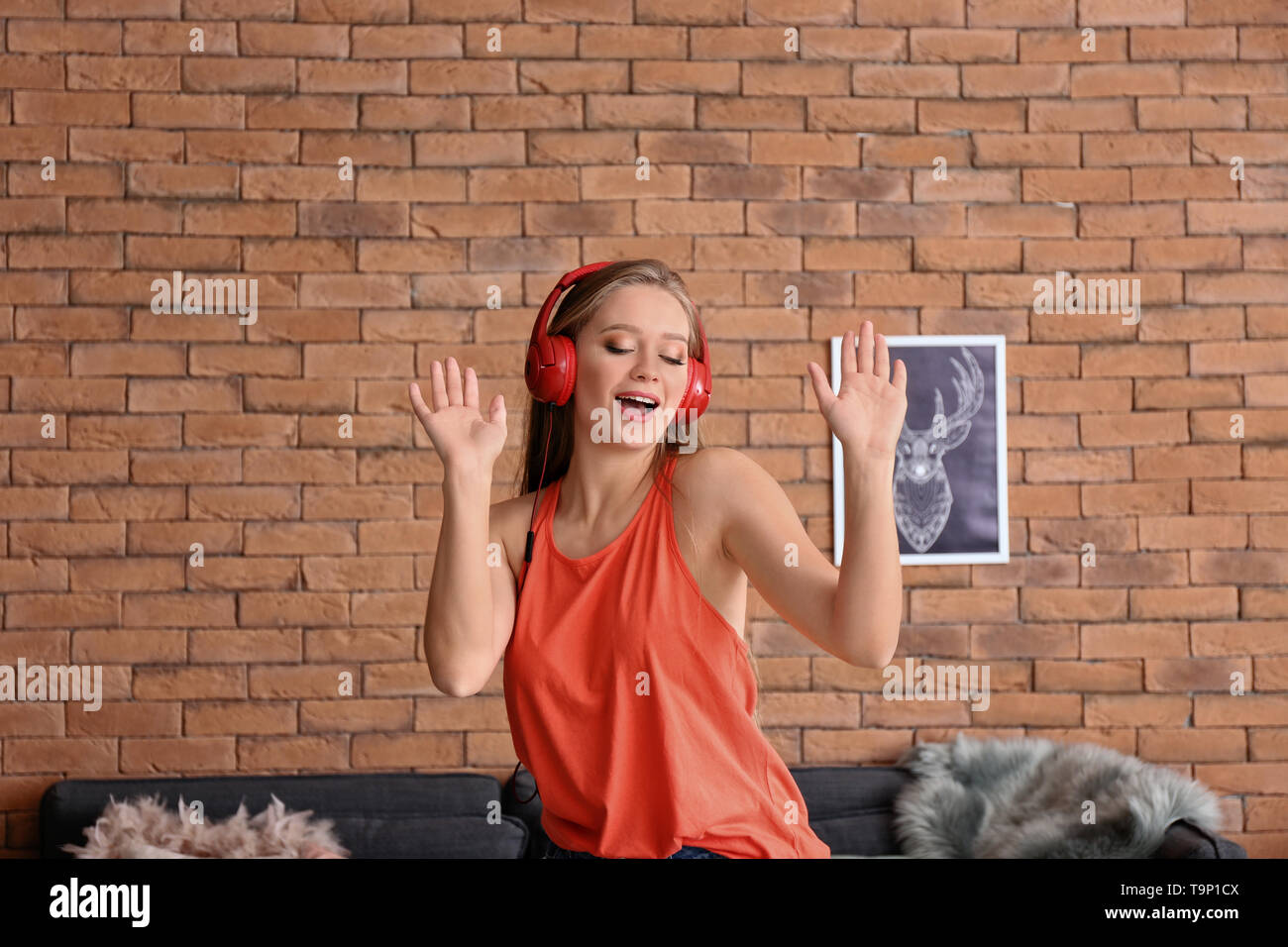 Beautiful young woman dancing at home Stock Photo - Alamy