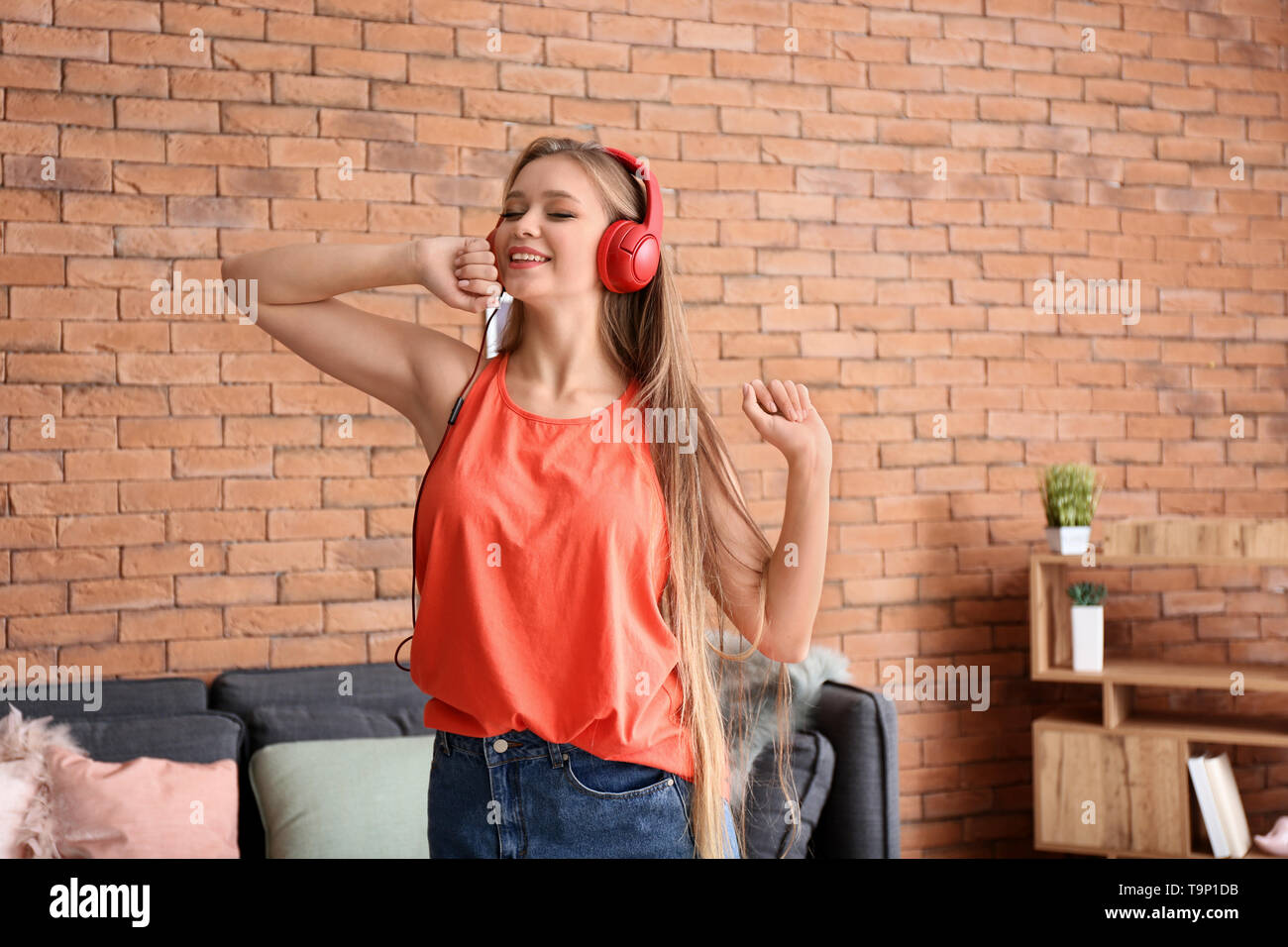 Beautiful young woman dancing at home Stock Photo - Alamy