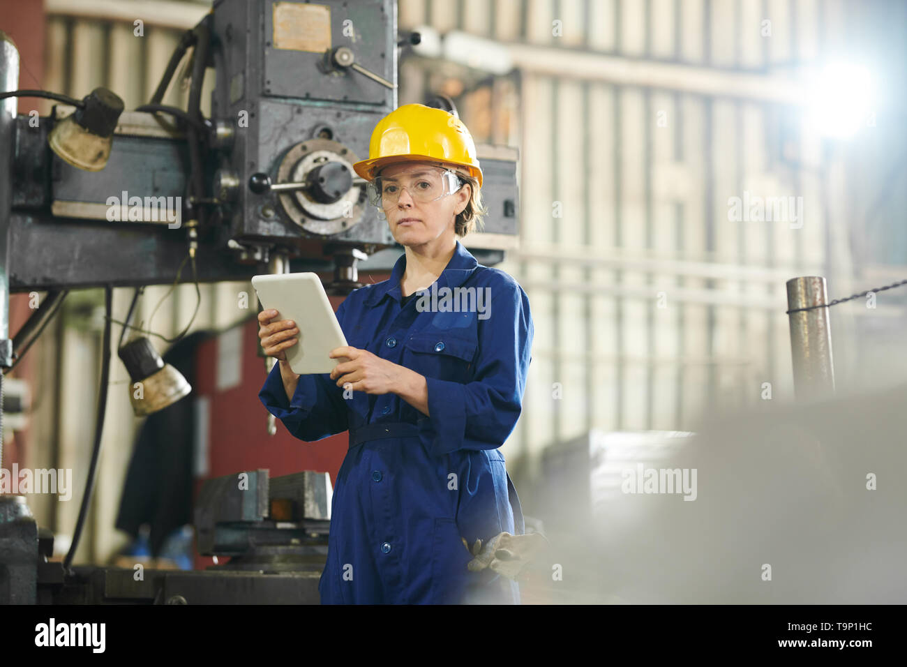 Female Worker Using Tablet at Factory Stock Photo - Alamy