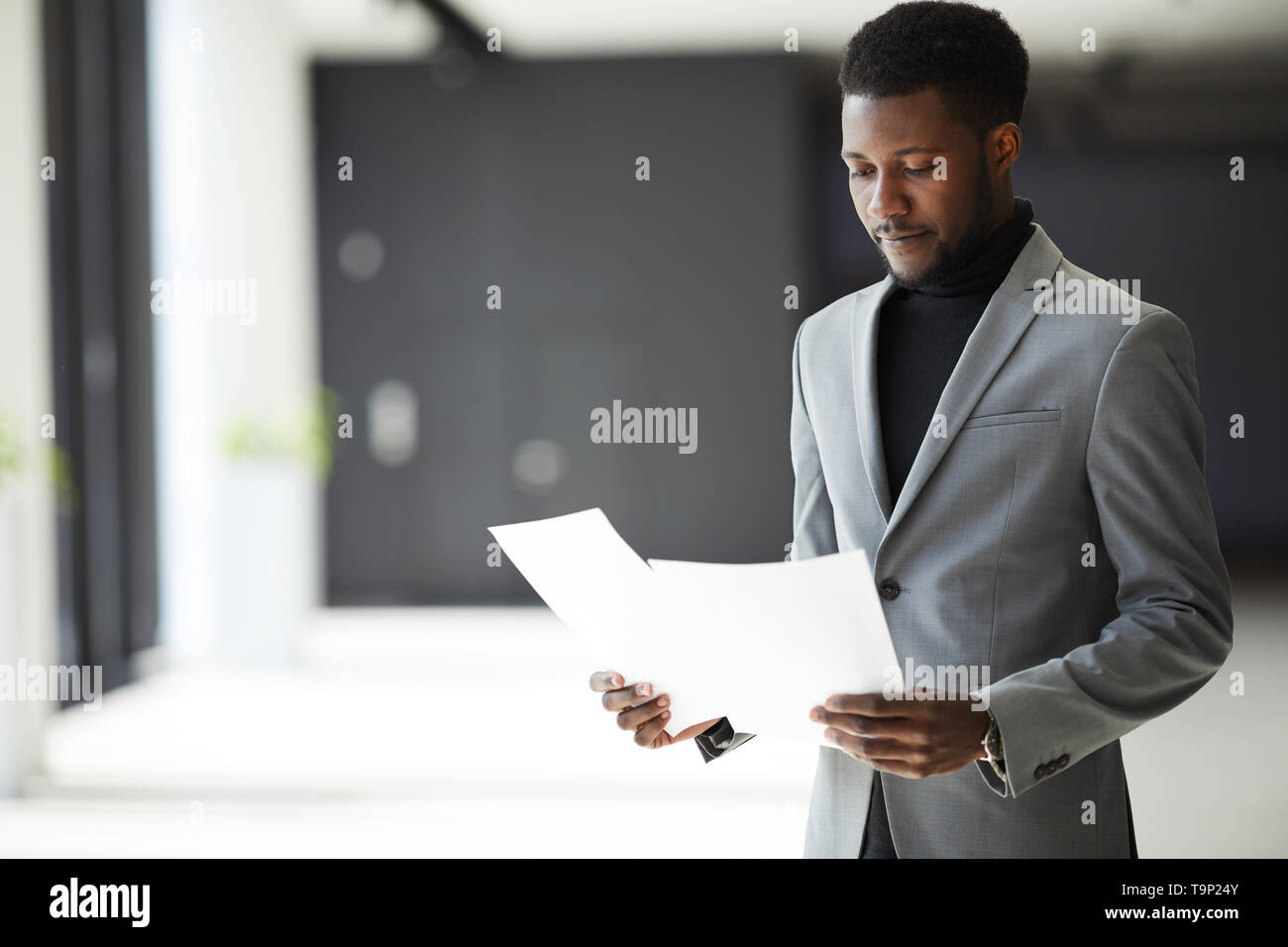 African-American manager examining documents Stock Photo - Alamy