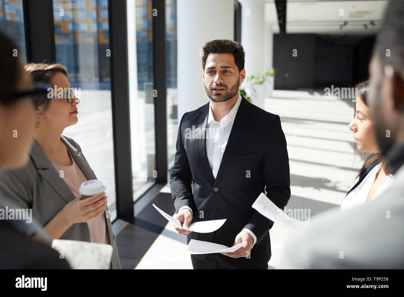 Mixed race manager explaining tasks Stock Photo - Alamy