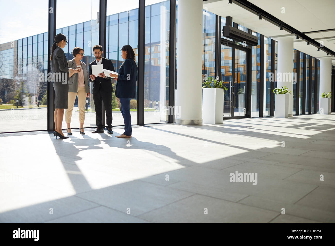 Business people analyzing paper data Stock Photo - Alamy