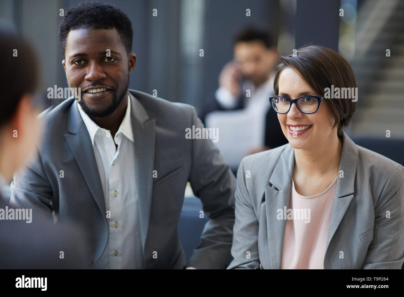 Business people interested in idea of colleague Stock Photo - Alamy