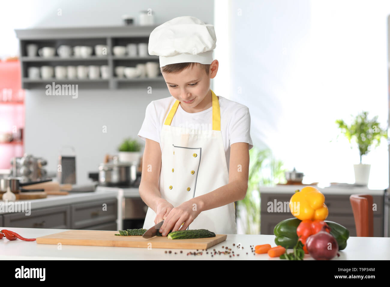 Cute little chef cooking in kitchen Stock Photo - Alamy
