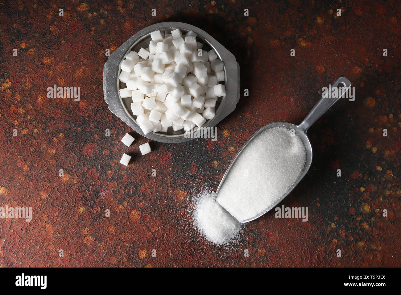Plate and scoop with refined sugar on table, top view Stock Photo - Alamy