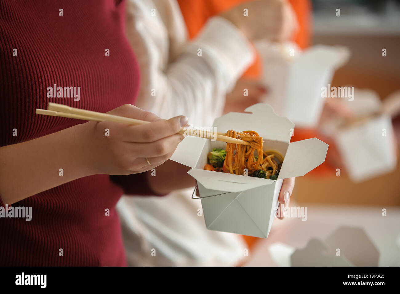 People eating chinese noodles from takeaway boxes, closeup Stock Photo ...