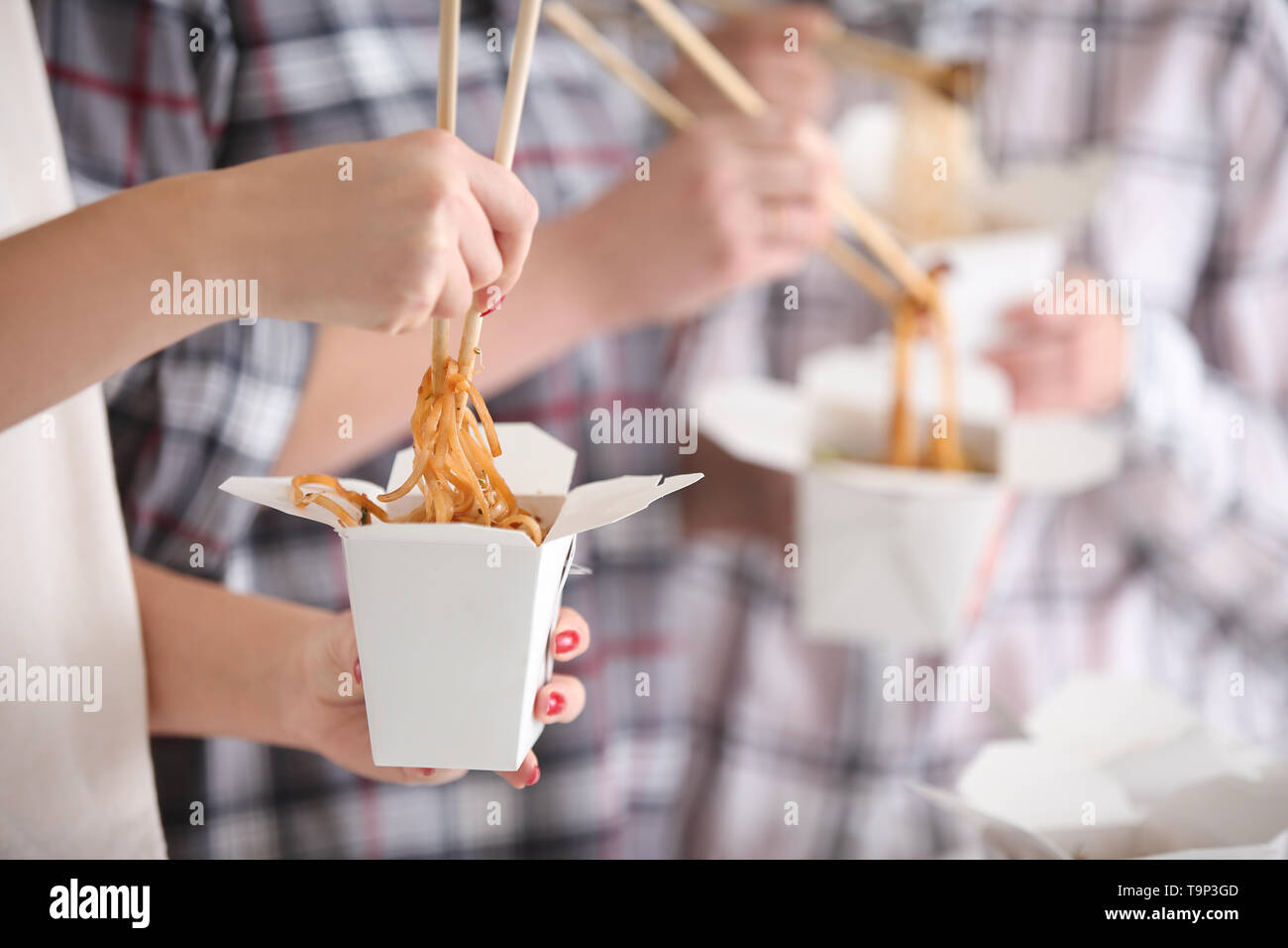 People eating chinese noodles from takeaway boxes, closeup Stock Photo ...