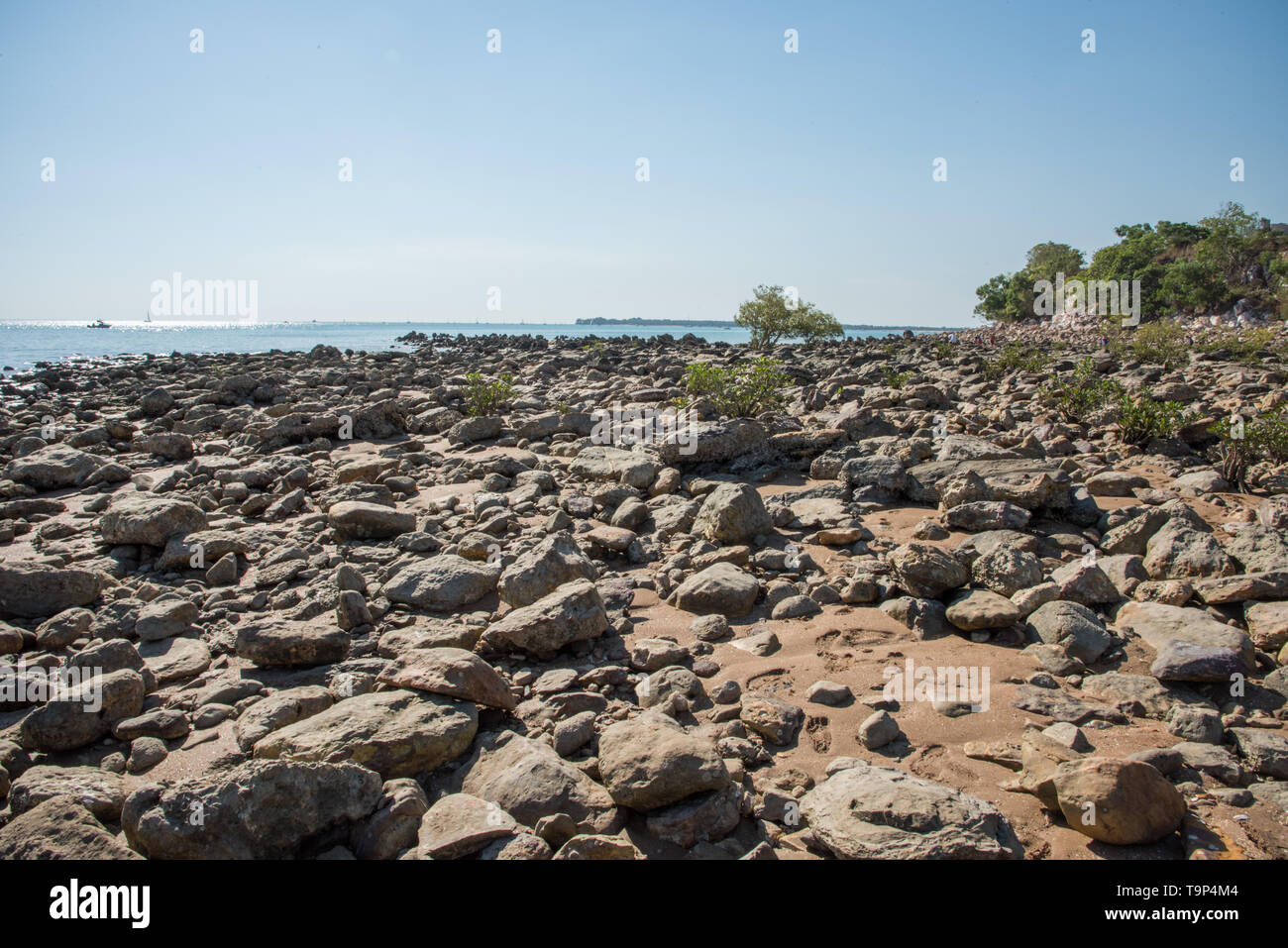 Coastal rock and Timor Sea view with nautical vessels from Mindil Beach ...