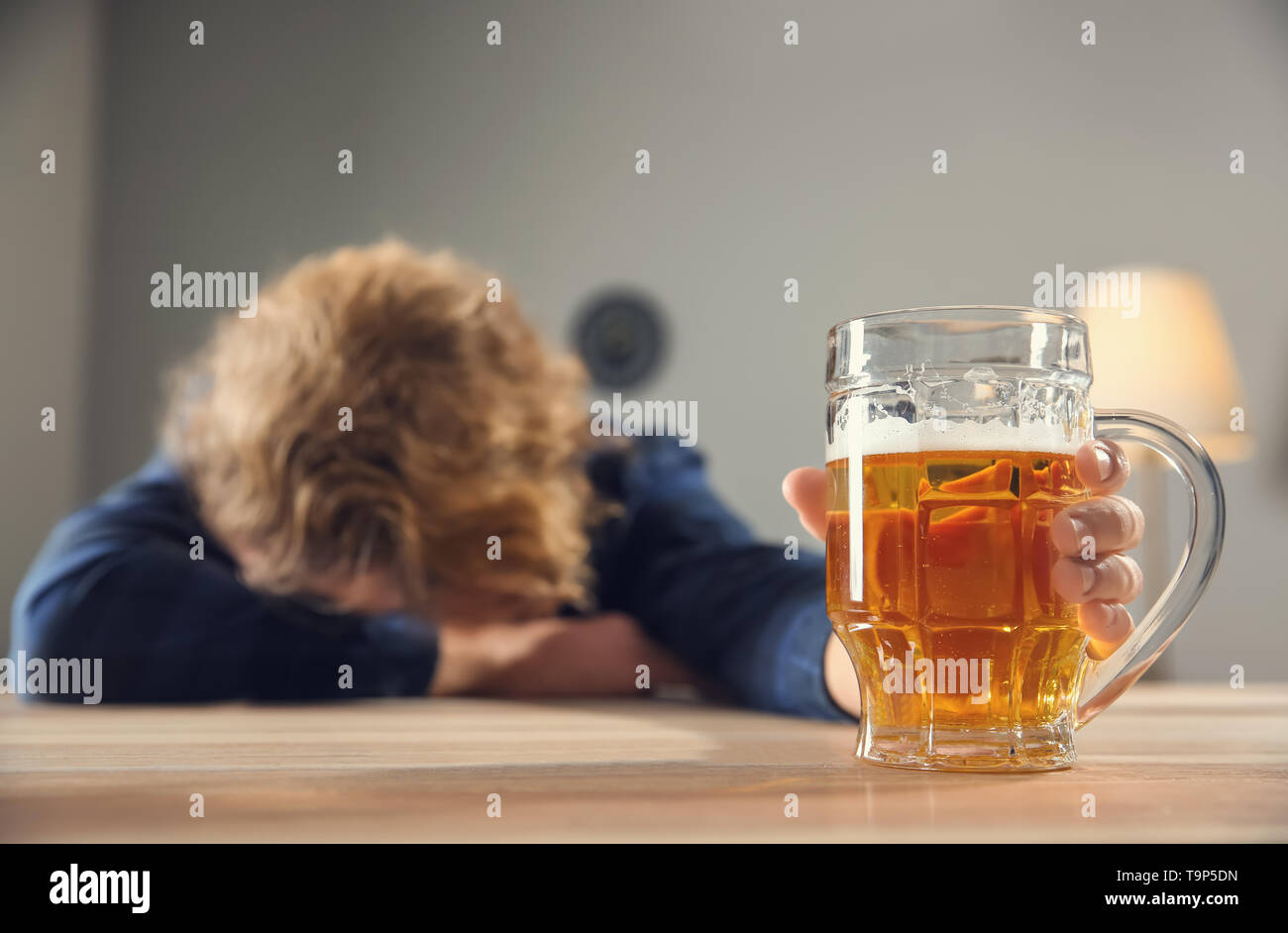 Unconscious drunk man with beer at table. Alcoholism concept Stock ...