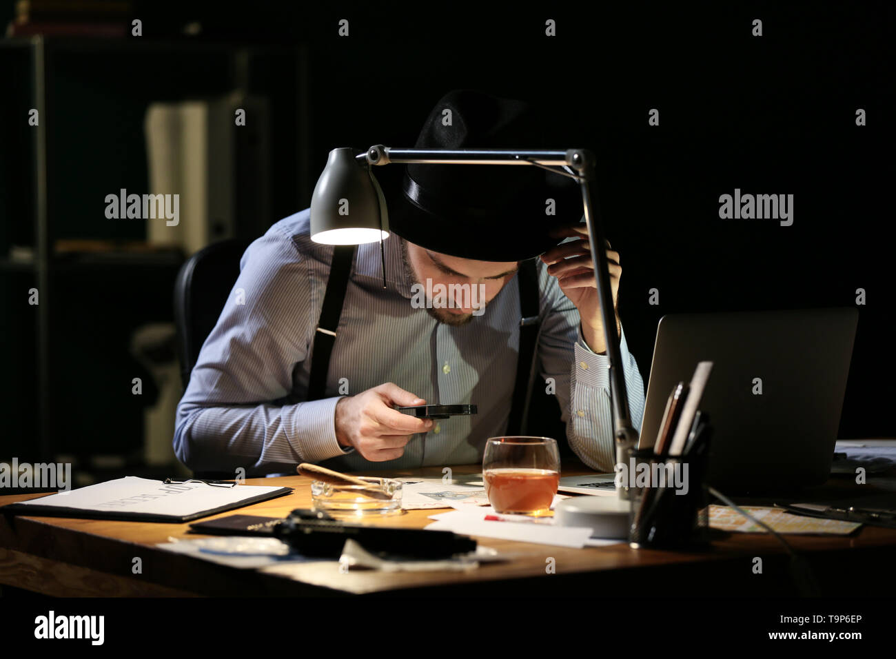 Detective processing evidence in office Stock Photo - Alamy