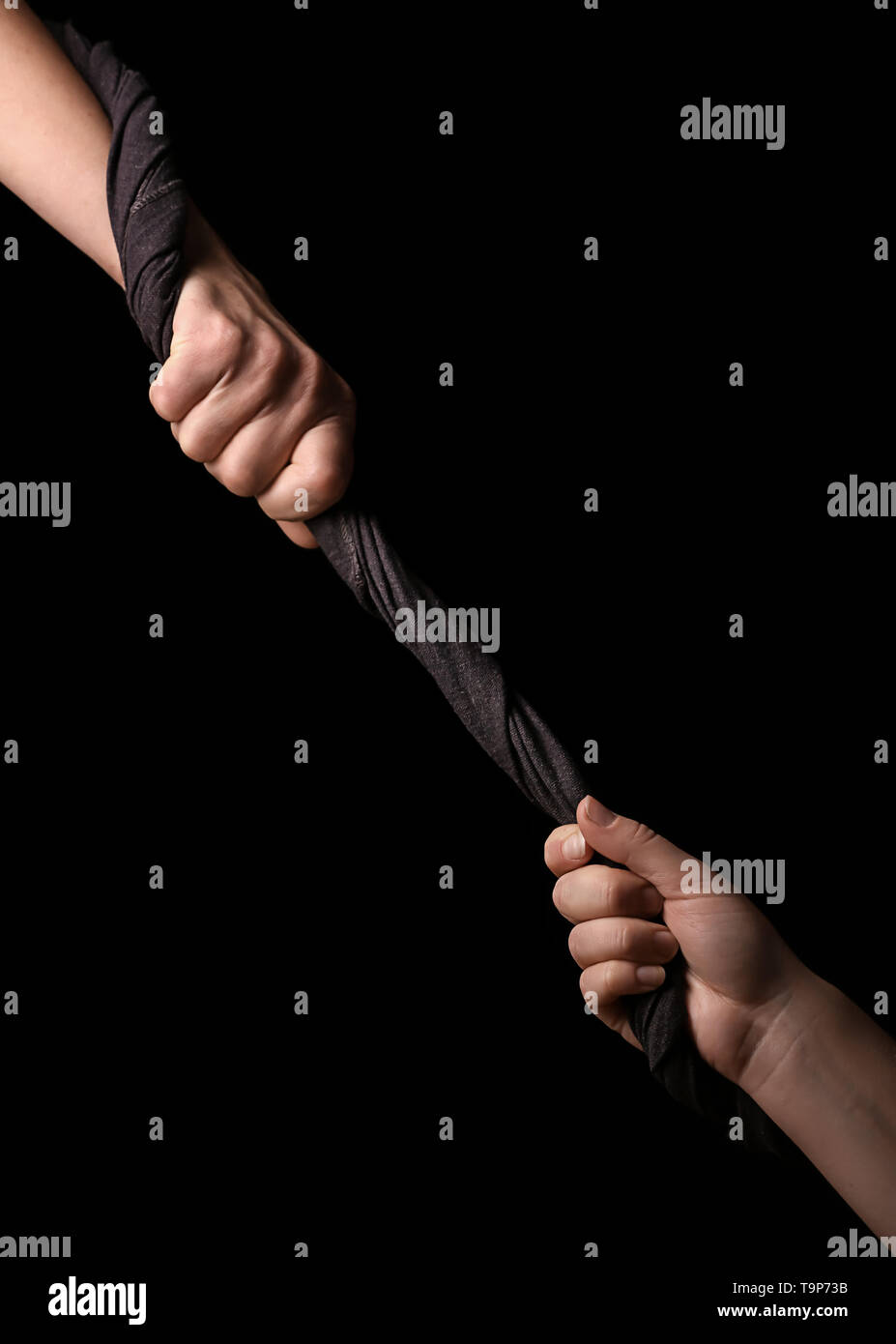 Female hands holding cloth on dark background Stock Photo - Alamy