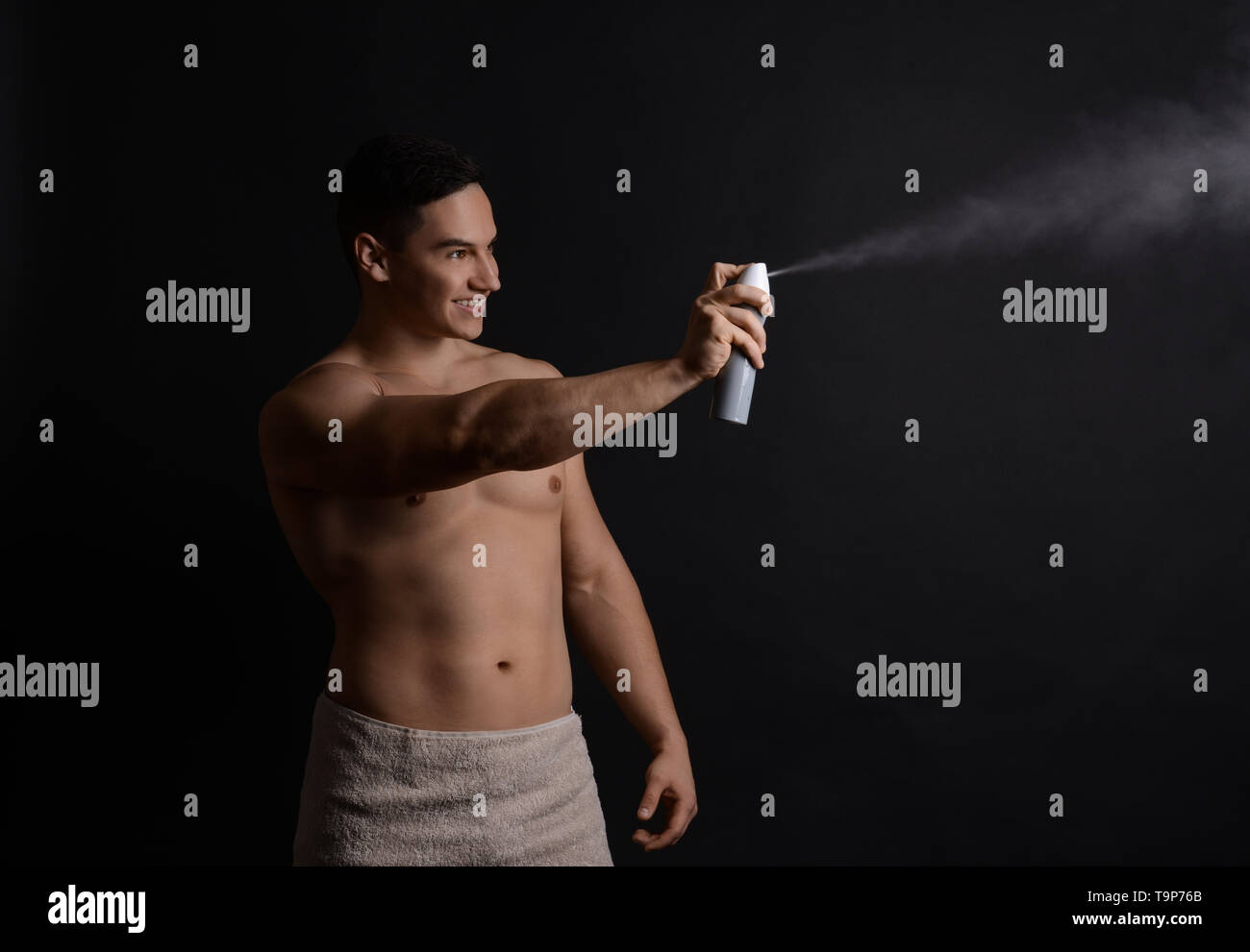 Man applying spray deodorant hi-res stock photography and images - Alamy
