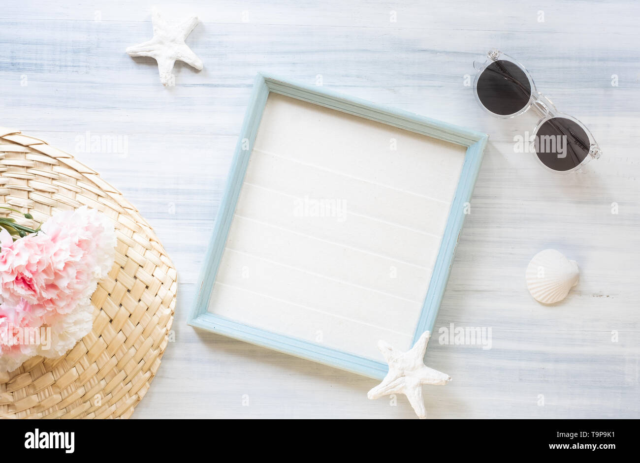 top view of summer blue picture frame with sunglasses and seashell and ...
