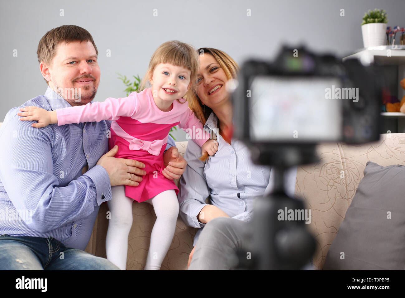 Young happy family sit on couch making photo session portrait Stock ...