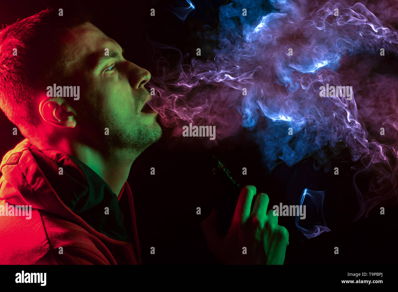 Portrait of a side mouth part of guys face with a colored backlight of ...