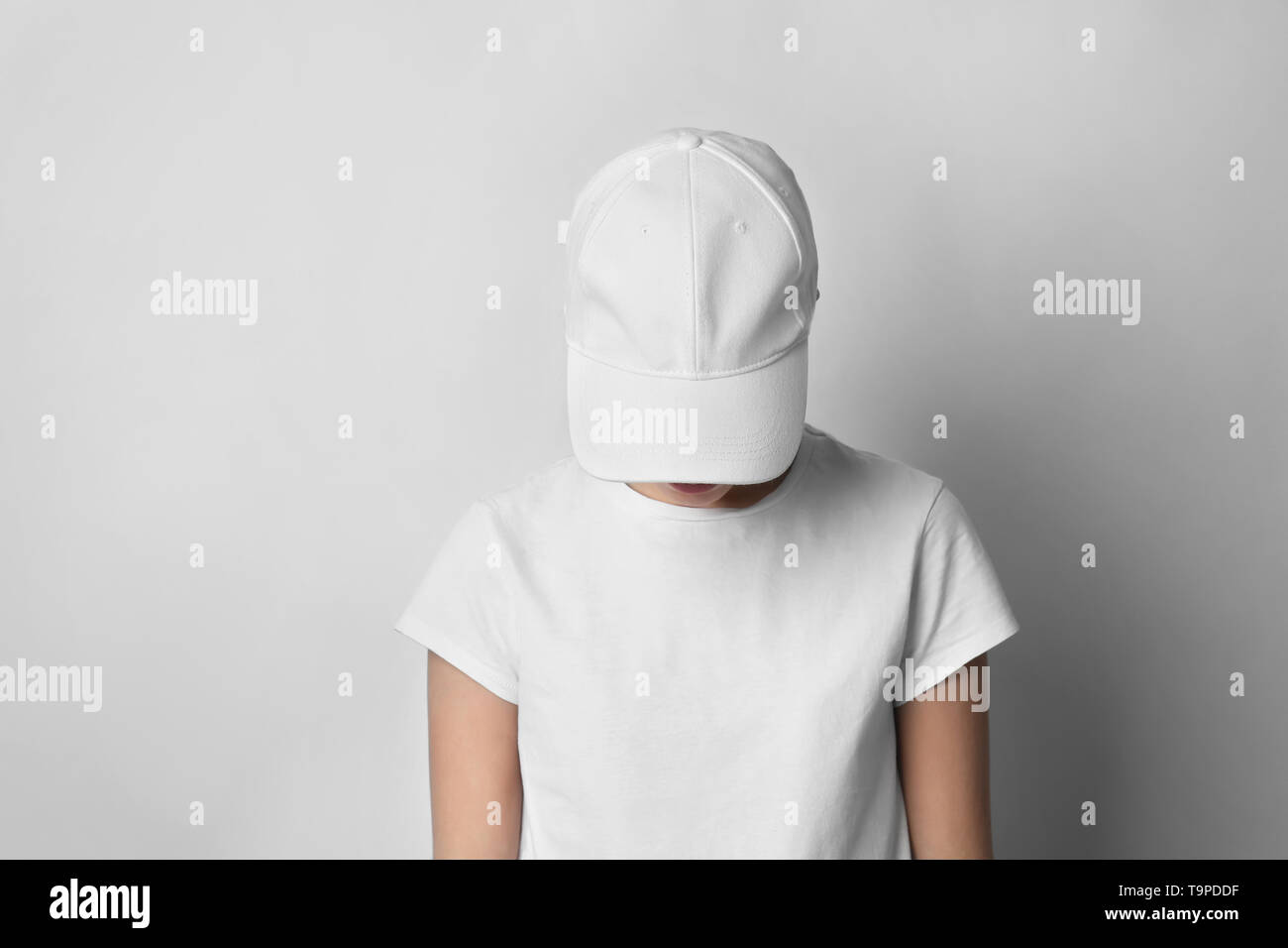 Woman wearing blank cap on light background Stock Photo - Alamy
