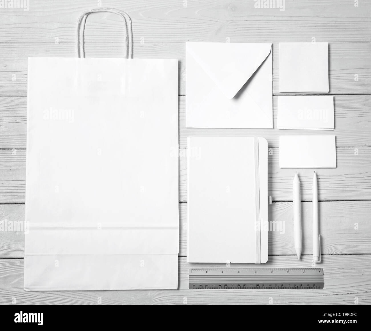 Set of items for branding on white wooden background Stock Photo - Alamy