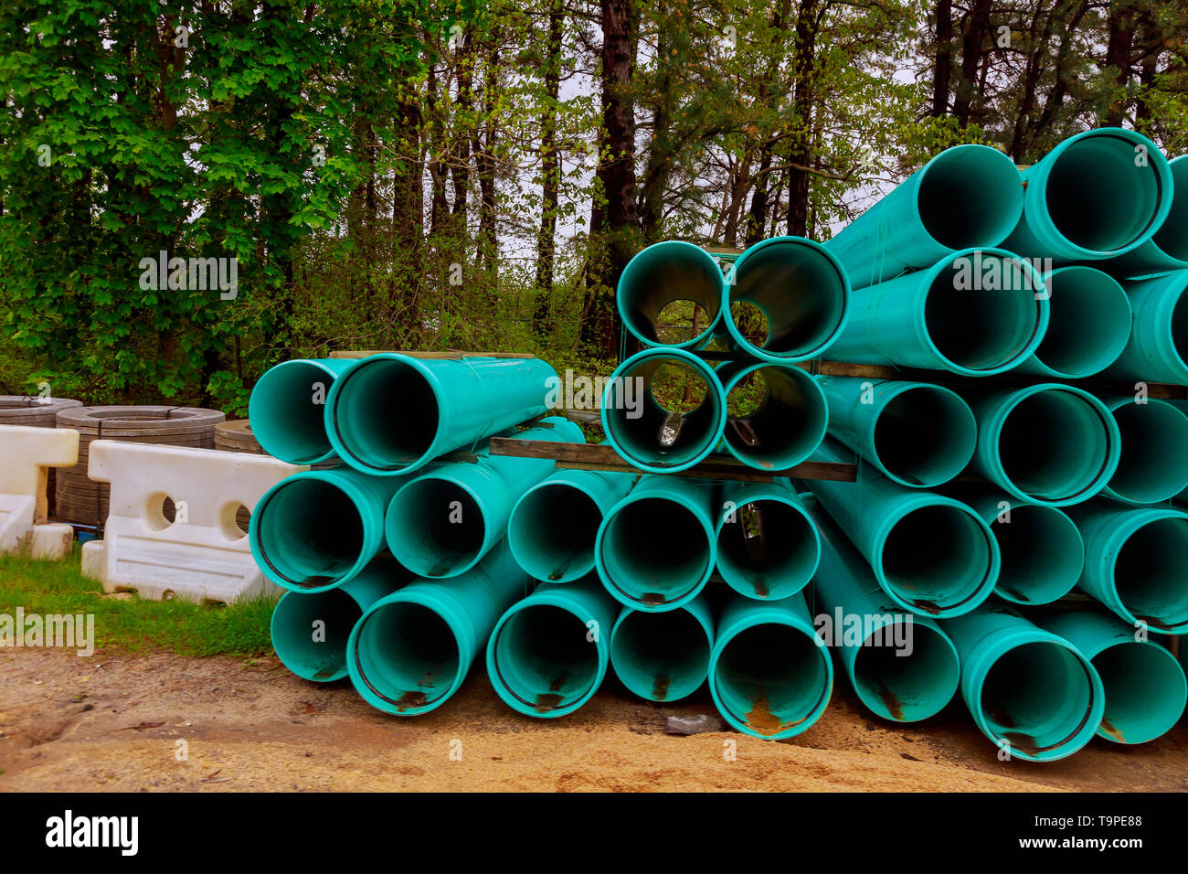 Pallets of green sewer PVC pipes at construction for drainage system ...