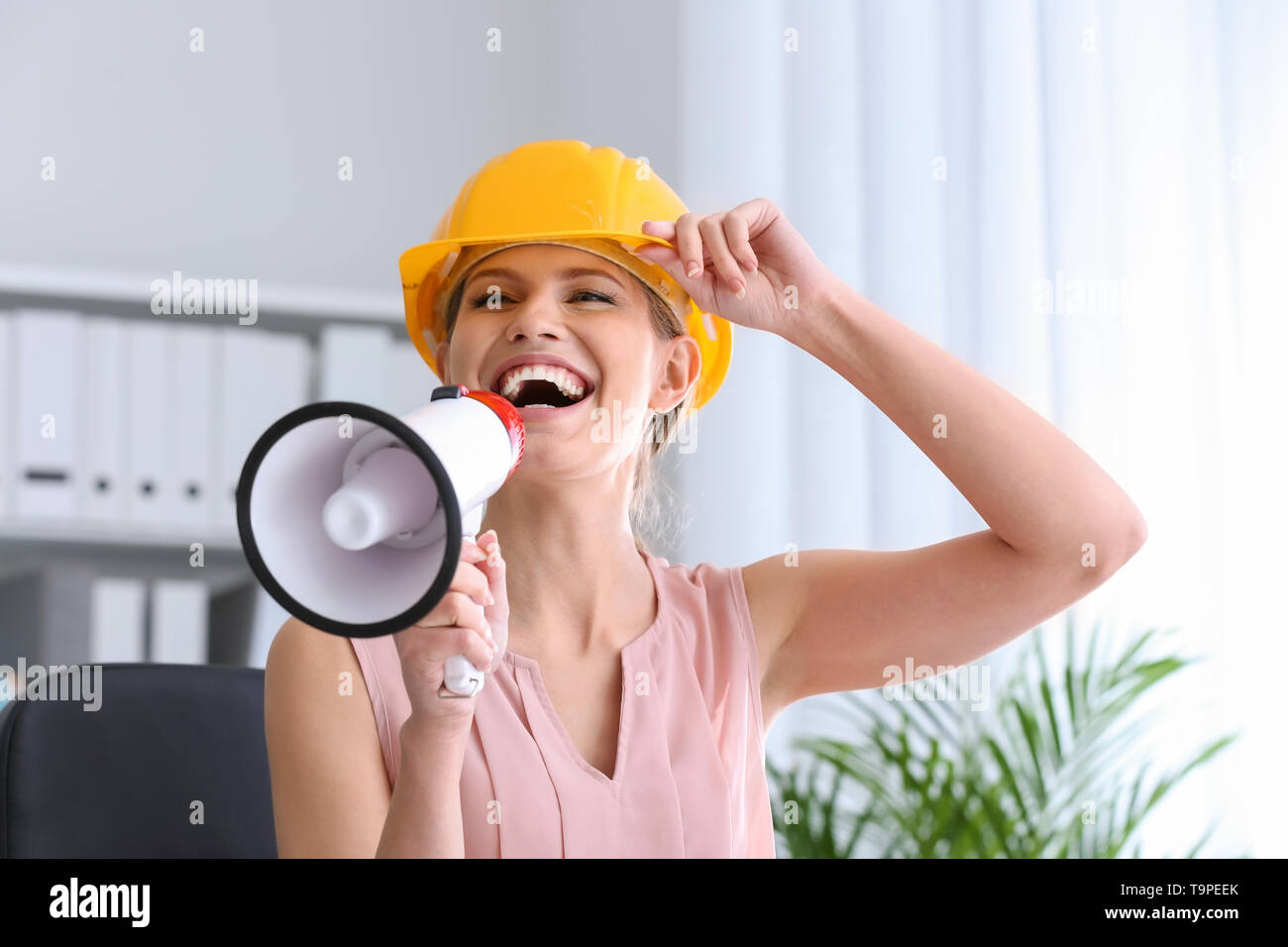 Female engineer using megaphone in office Stock Photo - Alamy