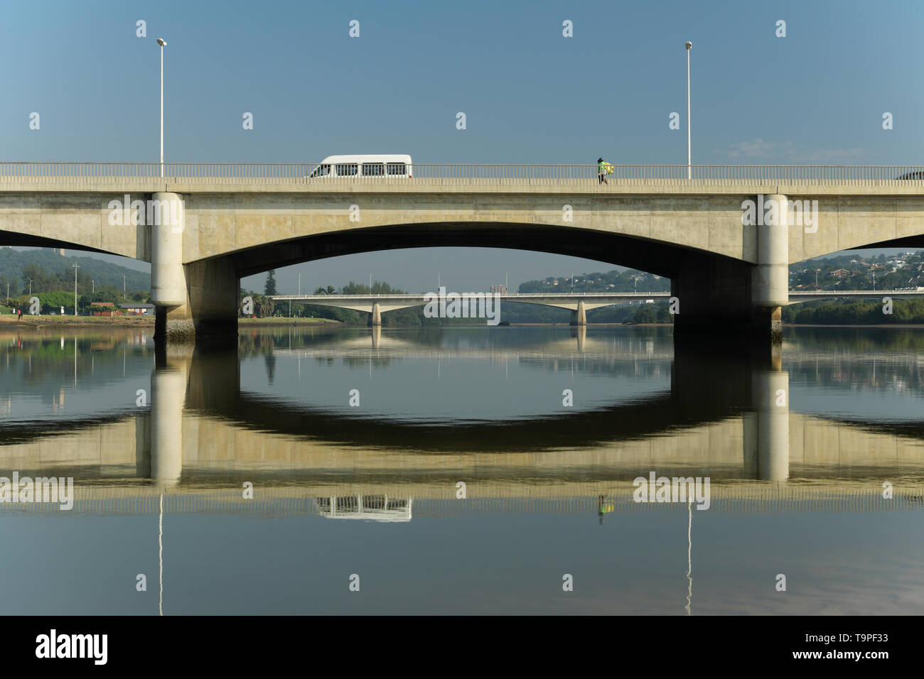 Single adult man with yellow bag walking over Umgeni river bridge, M4 ...