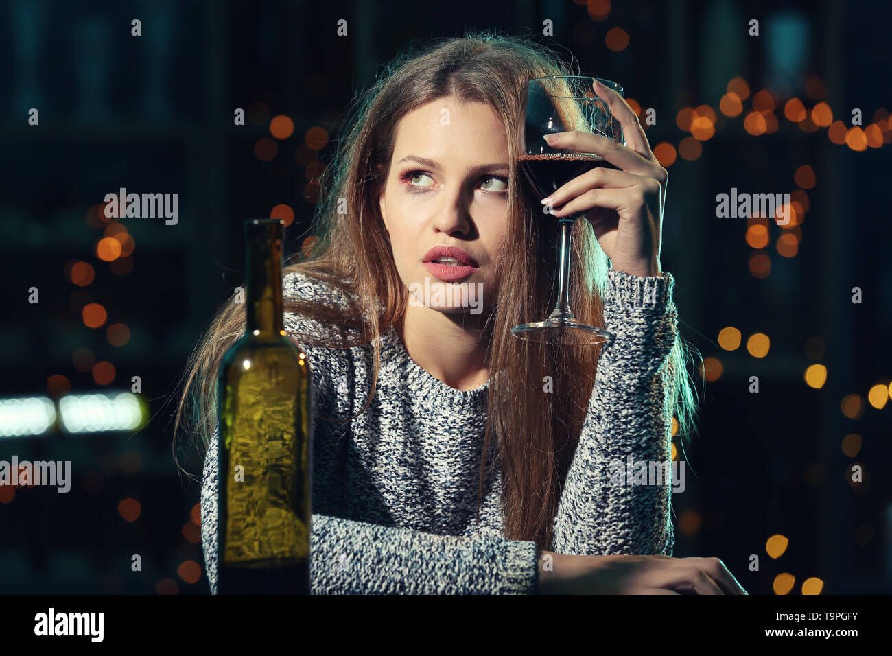 Young woman drinking alcohol in bar Stock Photo - Alamy