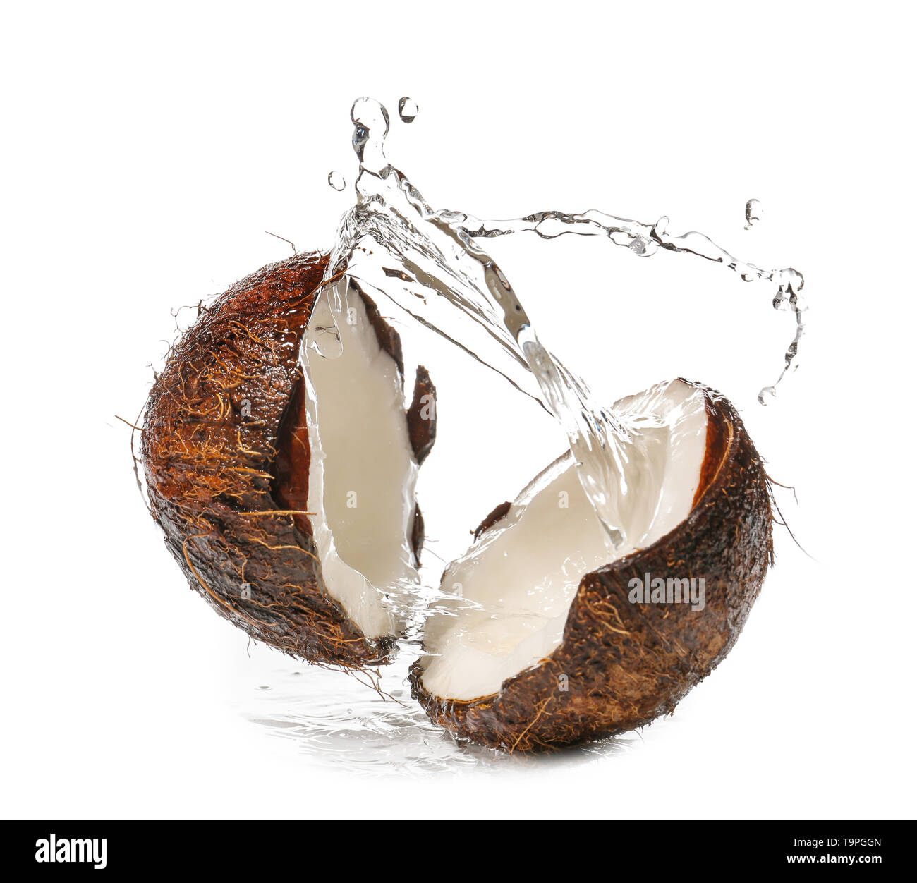 Halves of fresh coconut with water splash on white background Stock ...