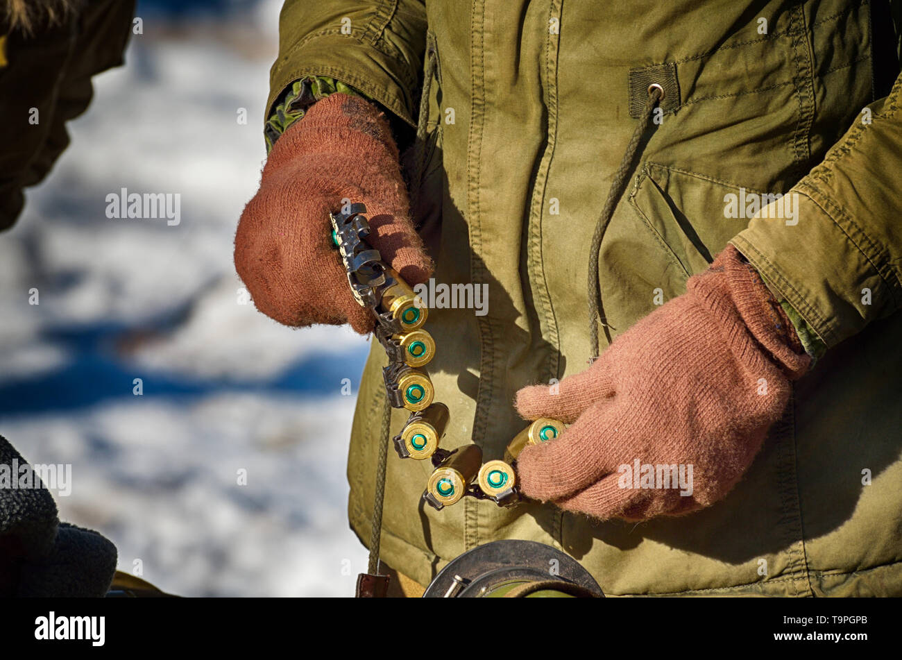 ammunition for the machine gun.The soldier is preparing for combat ...