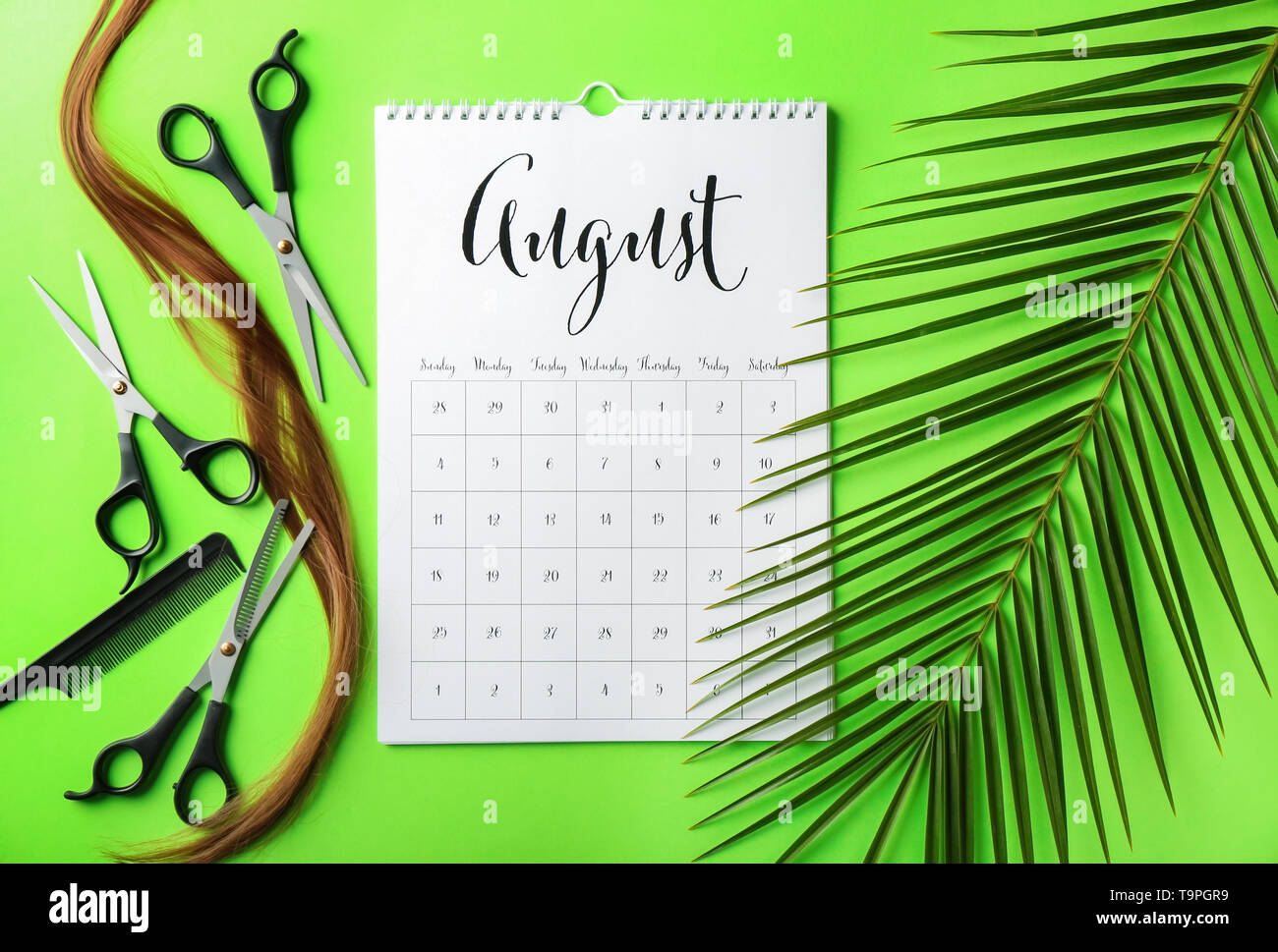 Calendar with hairdresser's scissors on color background Stock Photo ...