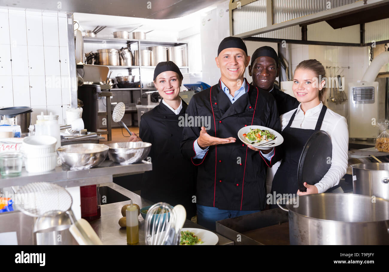 Successful multinational team of restaurant staff standing together in ...