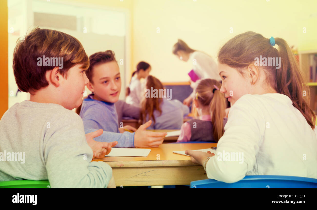Elementary students chatting during class hi-res stock photography and ...