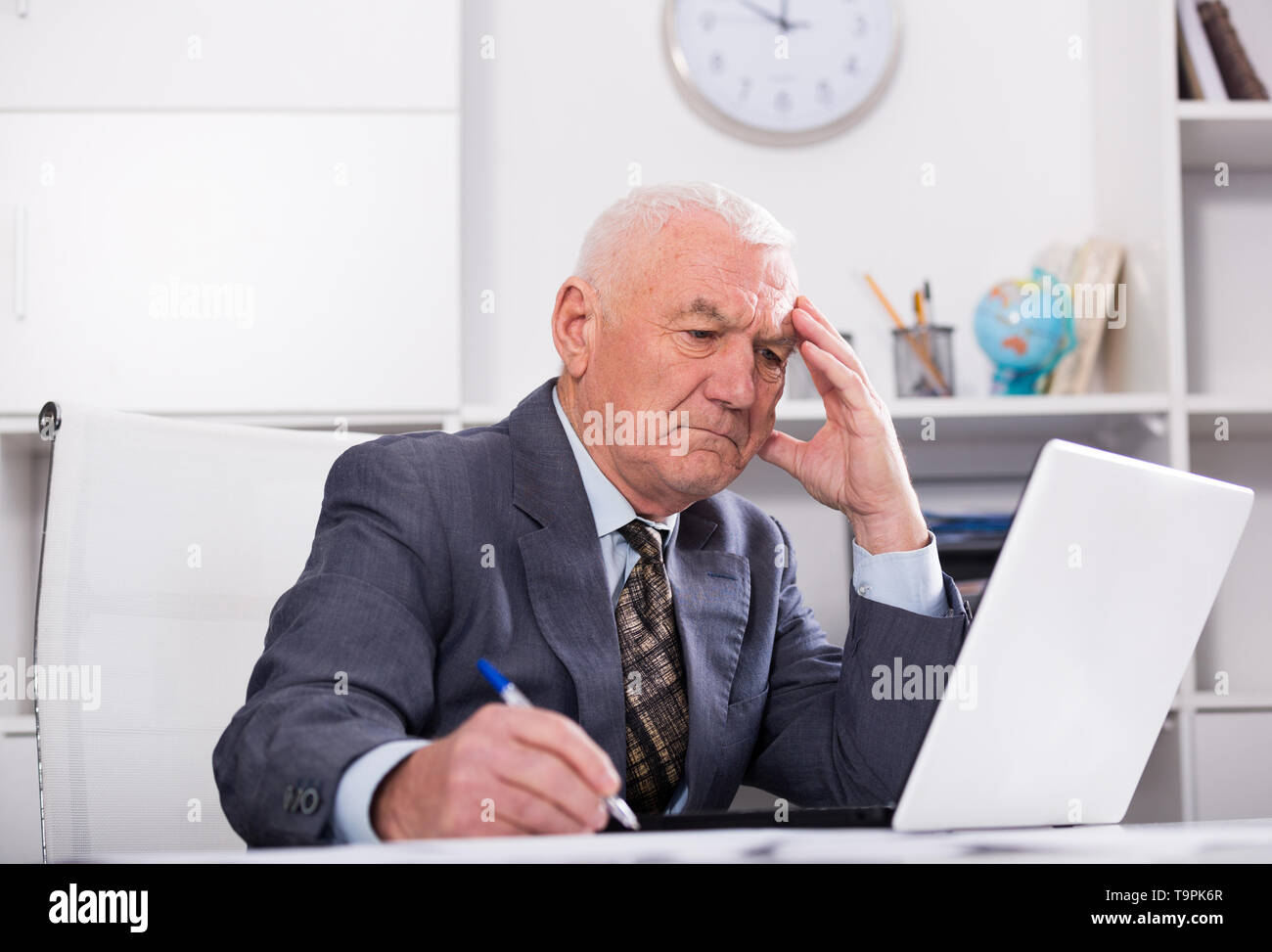 Smiling man worker working effectively on project in office Stock Photo ...