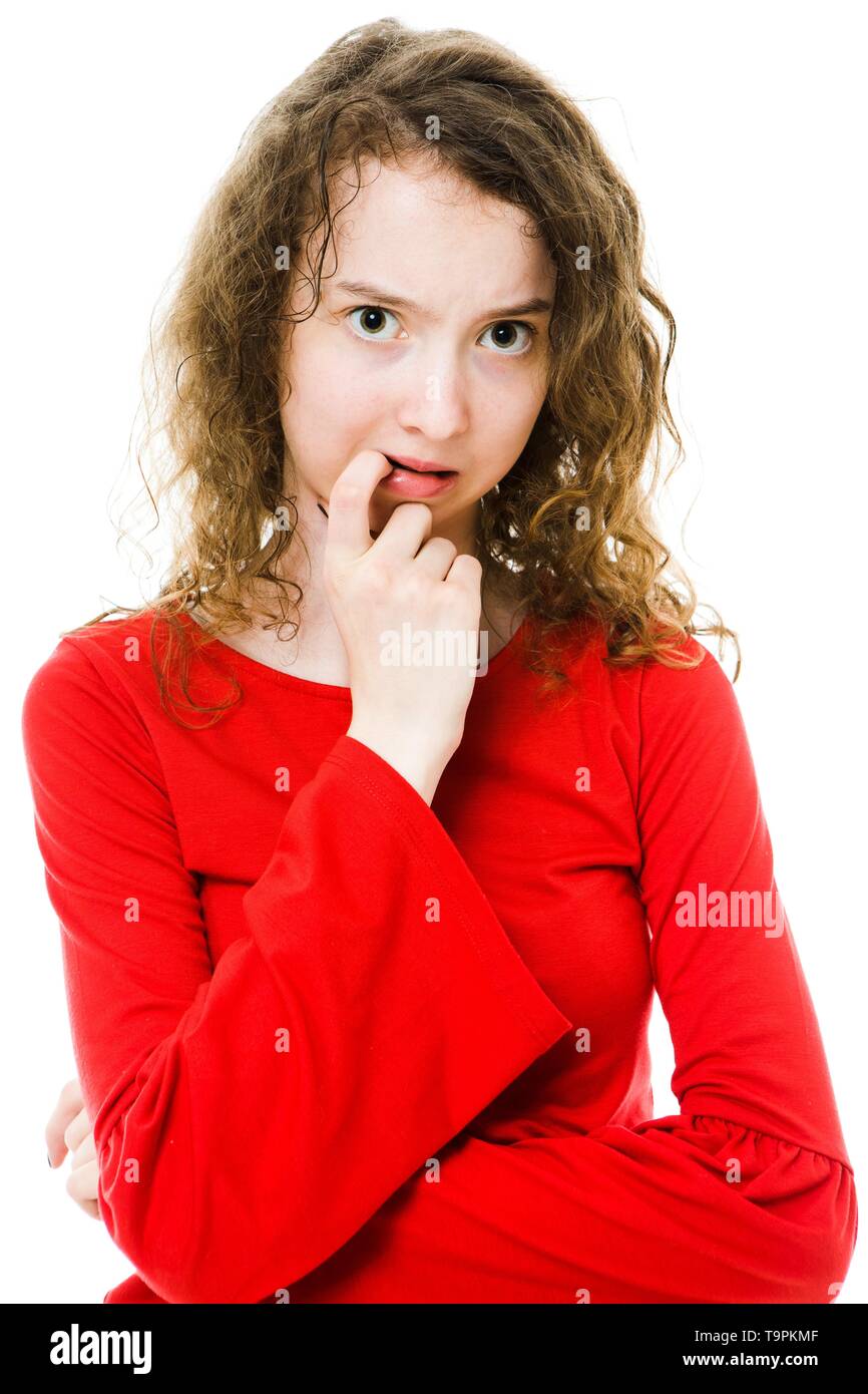 Nervous teenaged girl in red dress having doubts and stress - biting ...