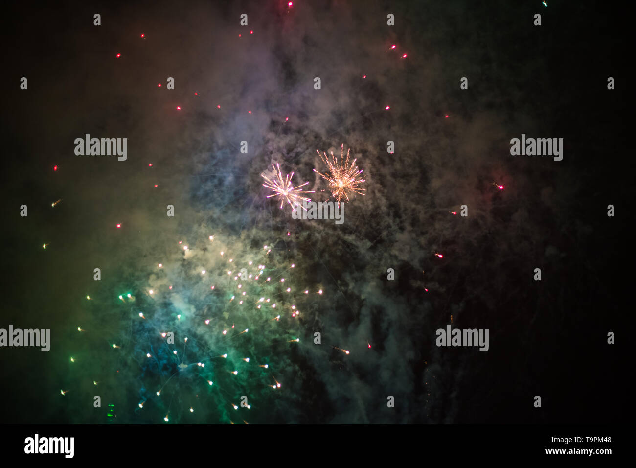 Explosive and colorful holiday fireworks at night sky. Celebration City ...