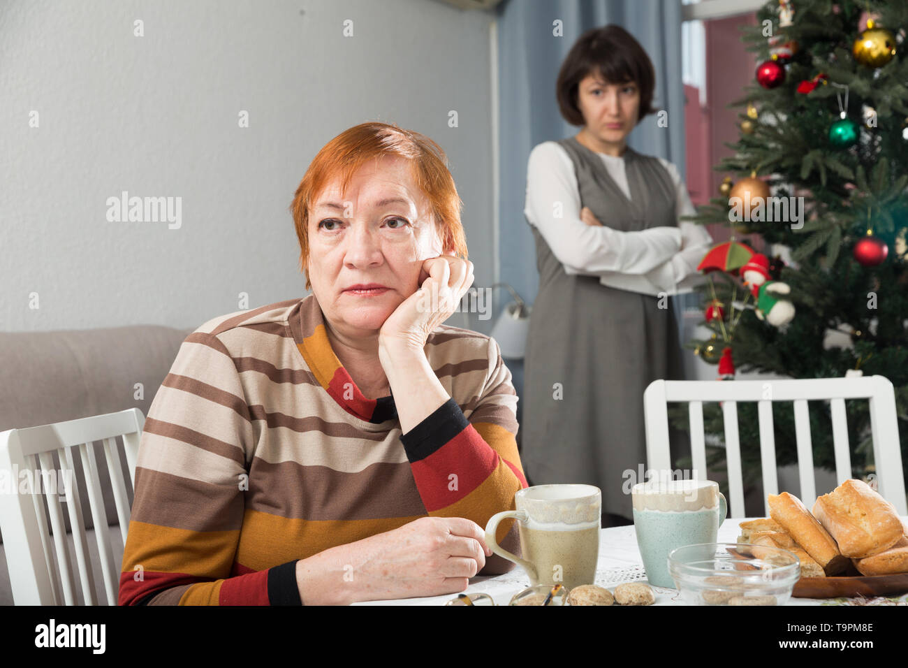 Quarrel of mother and daughter at the Christmas table Stock Photo - Alamy