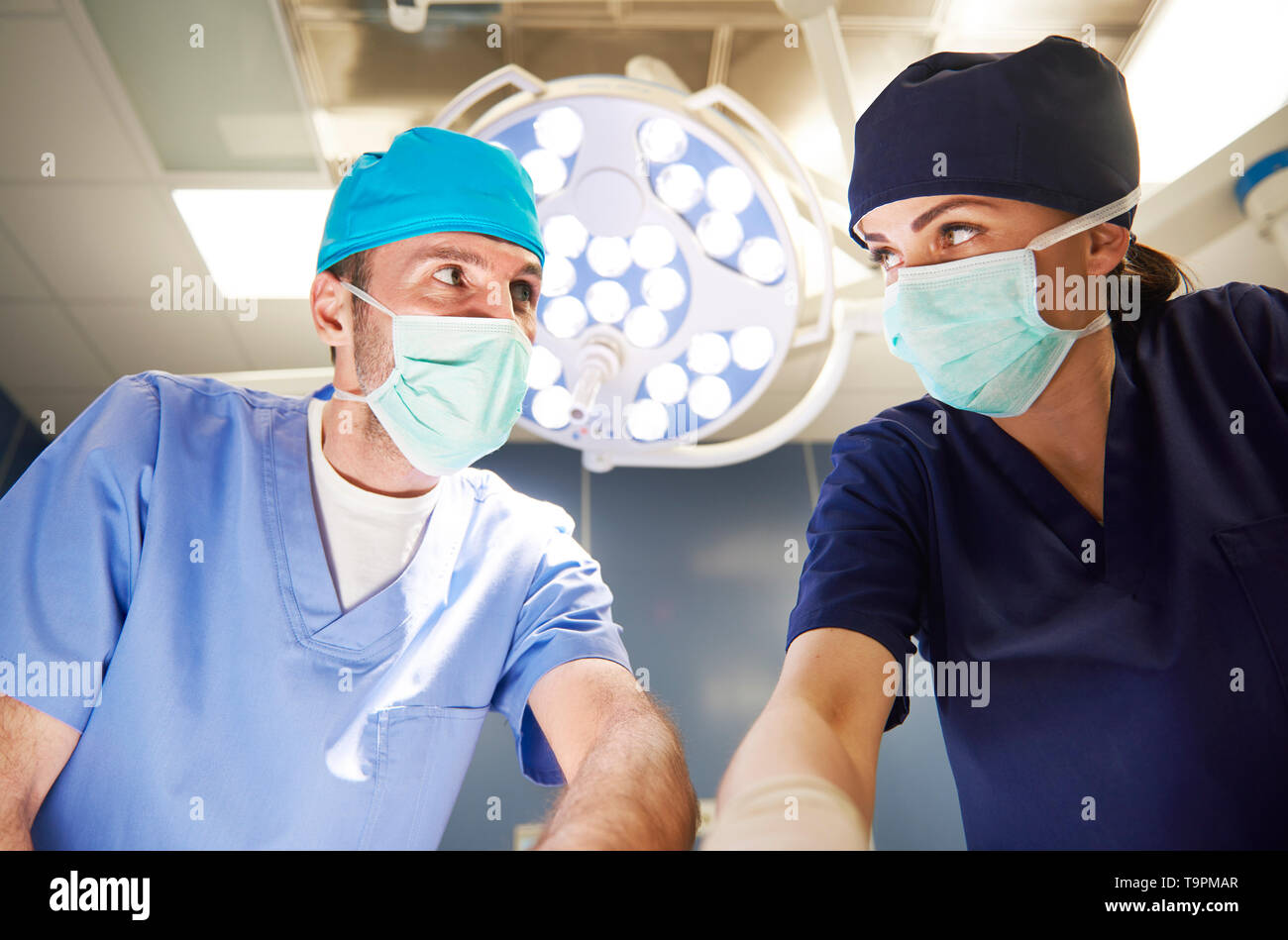 Two surgeons standing face to face Stock Photo - Alamy