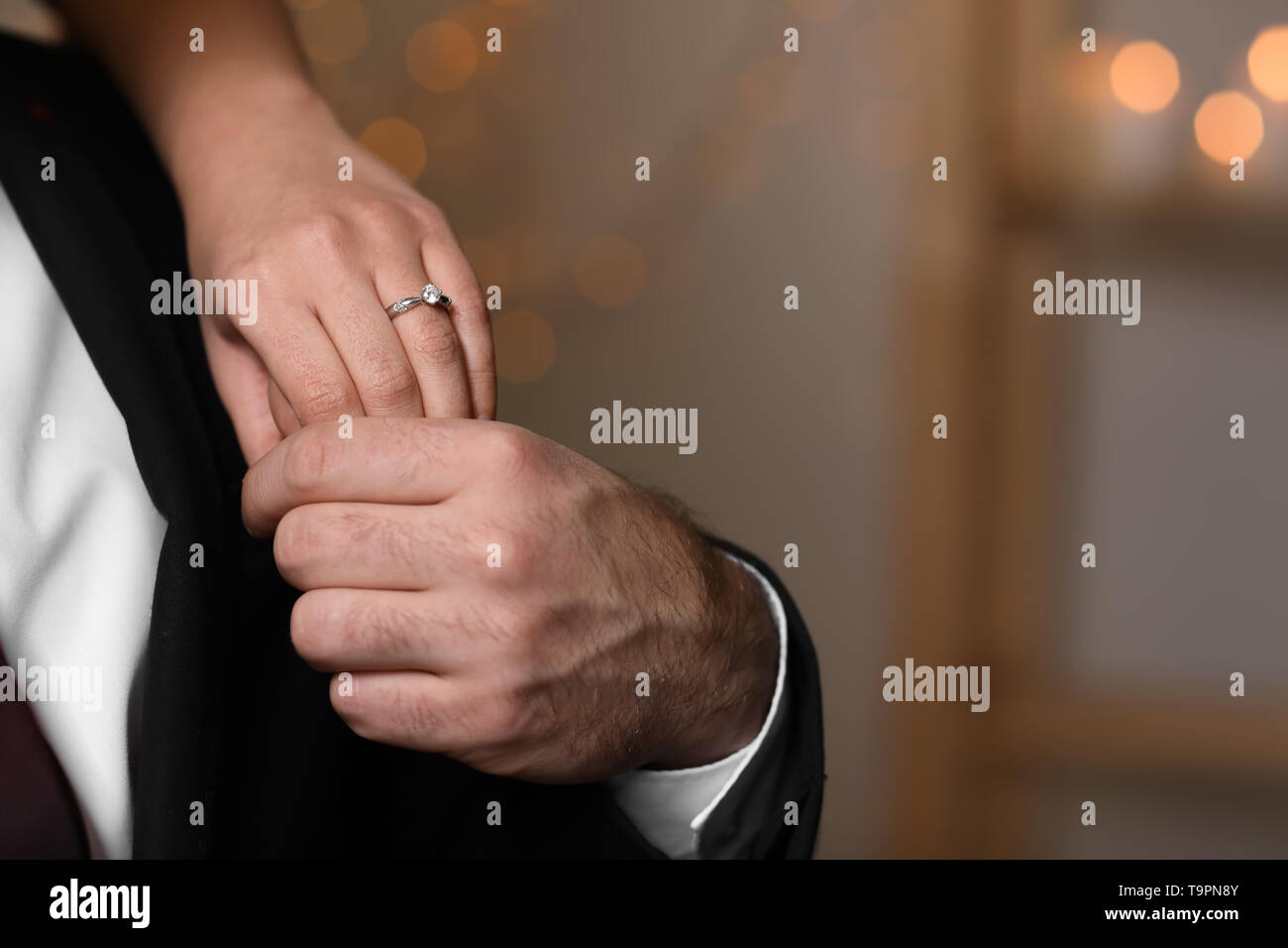 Engaged couple holding hands restaurant hi-res stock photography and ...