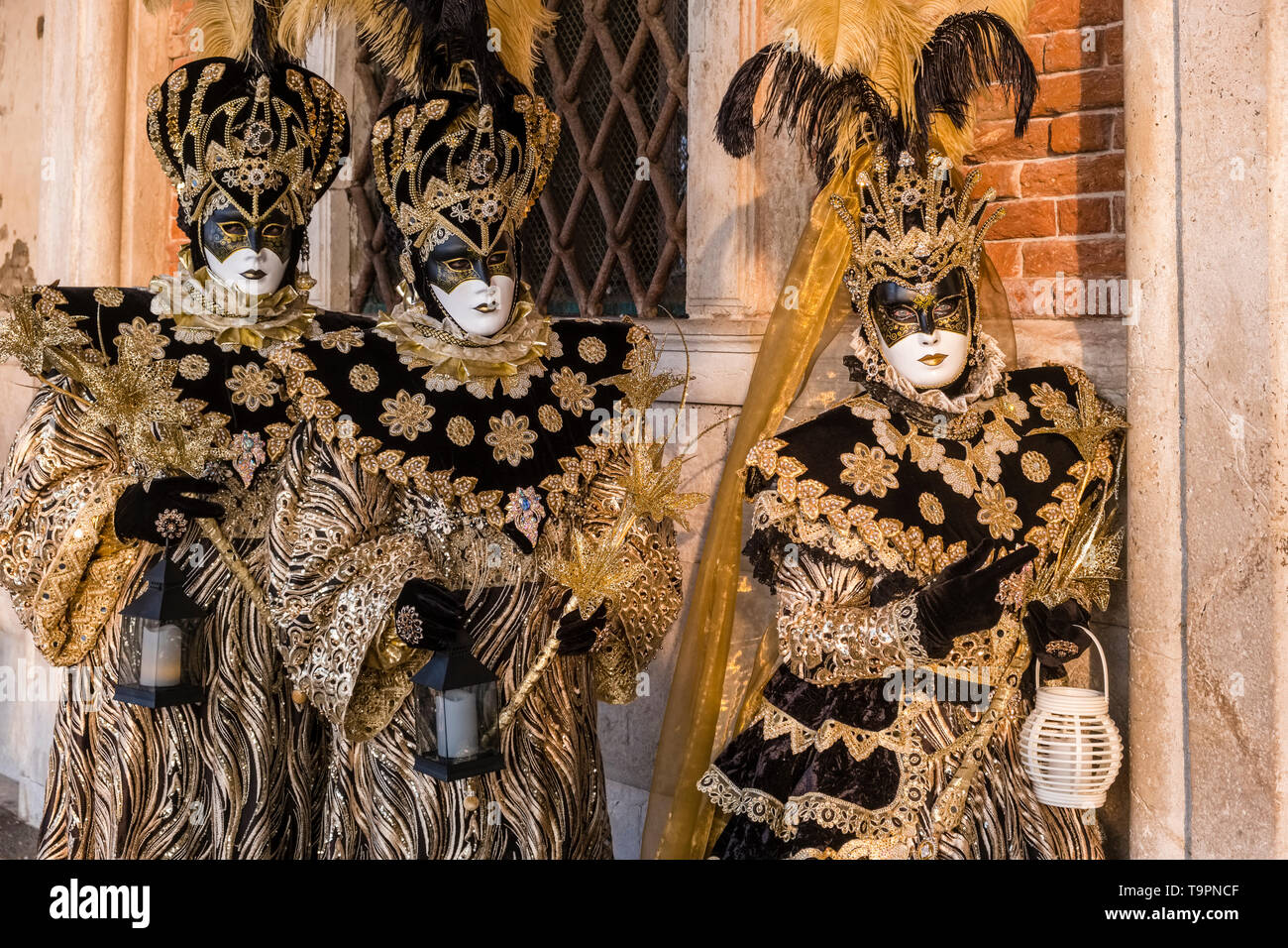 Portraits of a masked couple in beautiful creative harlequin costumes ...
