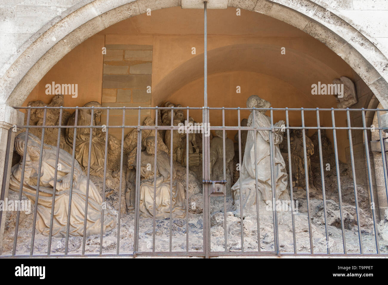 Religious sculptures behind a metal gate outside St. James Church (St ...